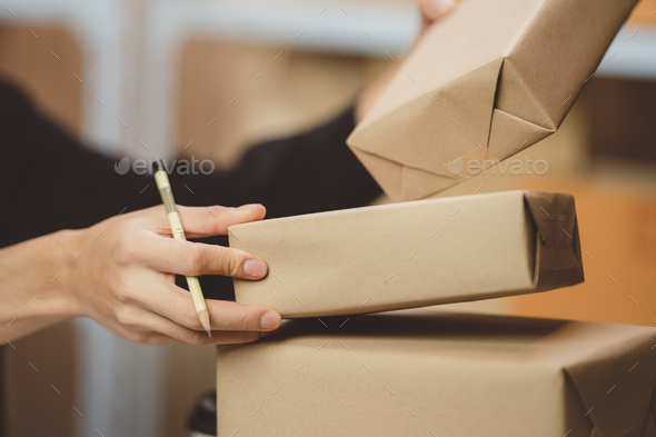 woman entrepreneur's hand holding package of parcel box, Preparing pack ...