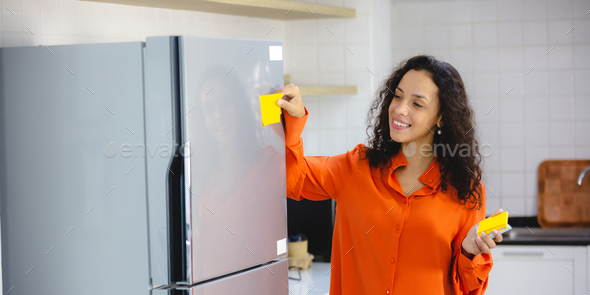 Young and organized female with curly hair in casual clothing making to ...