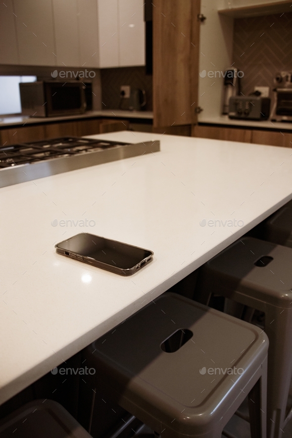 Modern phone on counter in kitchen mock-up friendly Stock Photo by ...