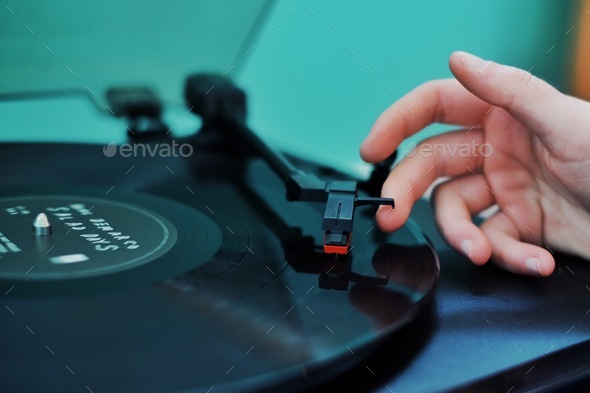 Record player, young woman moving the record player arm manually Stock ...