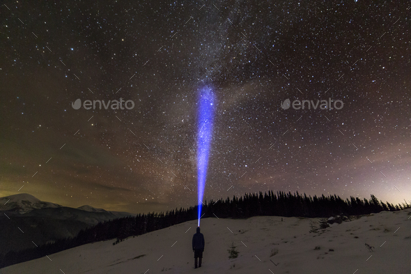 Back view of man with head flashlight standing on snowy valley Stock ...