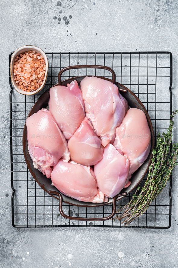Boneless and skinless Raw Chicken leg thigh fillet. Gray background ...