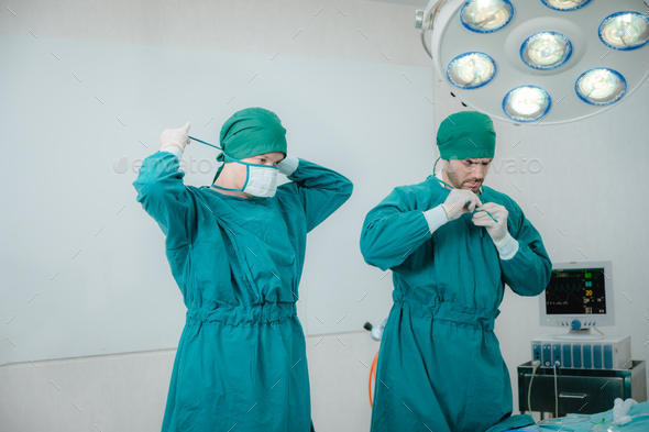 surgical doctor person are wearing protected suit medical operation ...