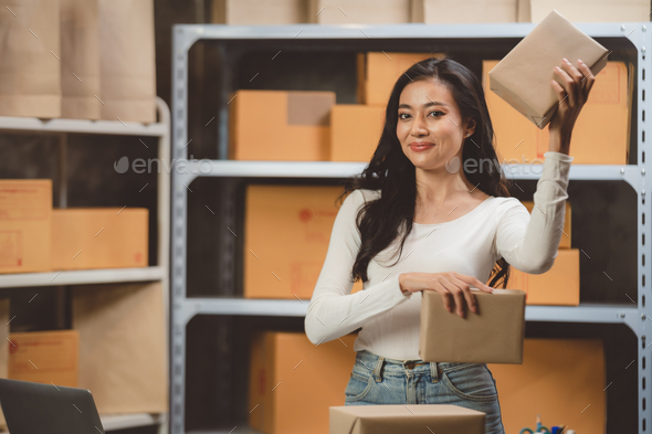 woman entrepreneur's hand holding package of parcel box, Preparing pack ...