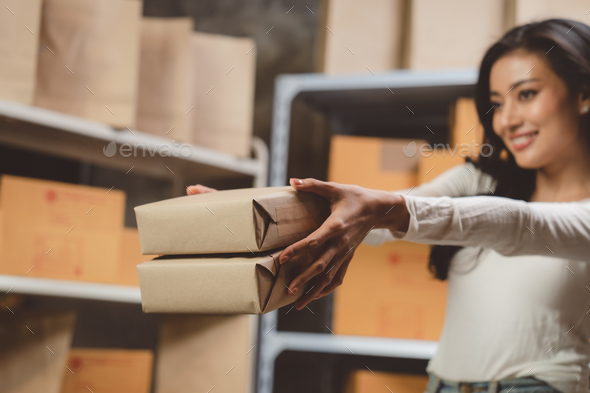 woman entrepreneur's hand holding package of parcel box, Preparing pack ...