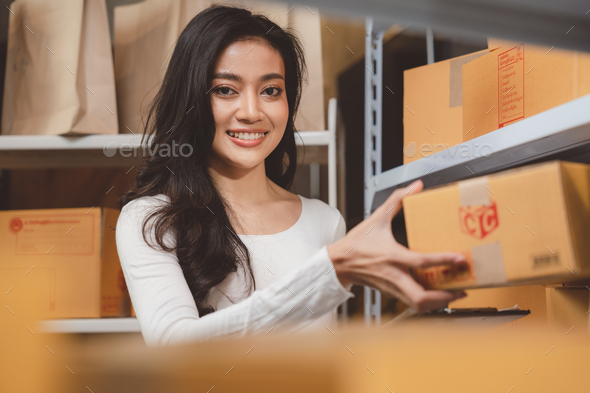 woman entrepreneur's hand holding package of parcel box, Preparing pack ...
