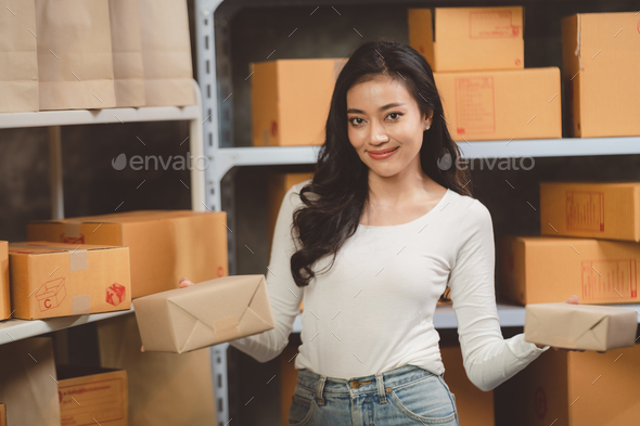 woman entrepreneur's hand holding package of parcel box, Preparing pack ...
