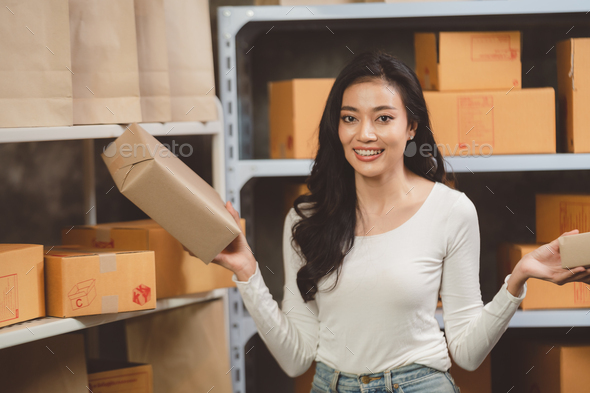woman entrepreneur's hand holding package of parcel box, Preparing pack ...