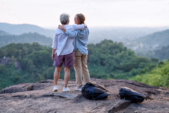 Backpack adventure hiking traveler mother and daughter standing hug on ...