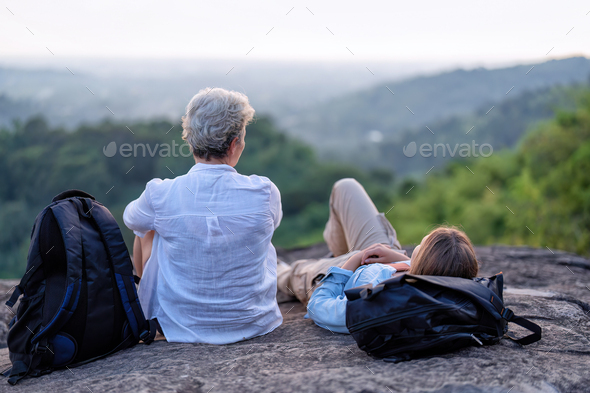Backpack adventure hiking traveler mother and daughter sit and laying ...