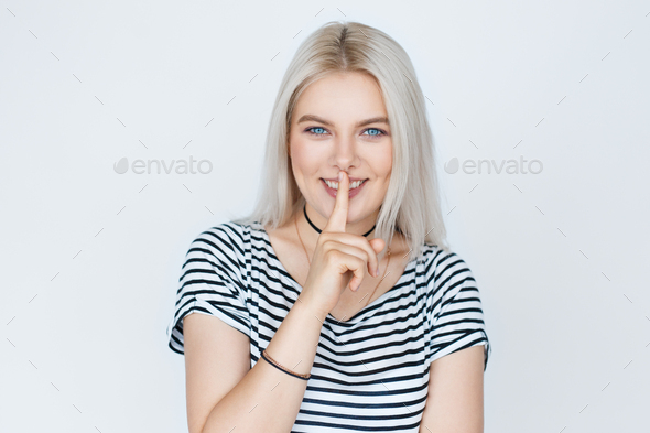 Cute young woman keeping a secret Stock Photo by kegfire | PhotoDune