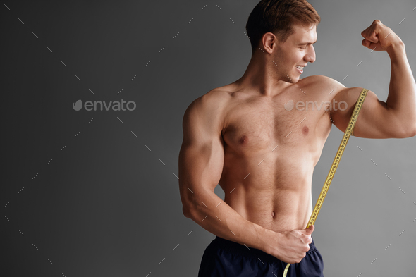 Bodybuilder measuring muscle Stock Photo by kegfire | PhotoDune