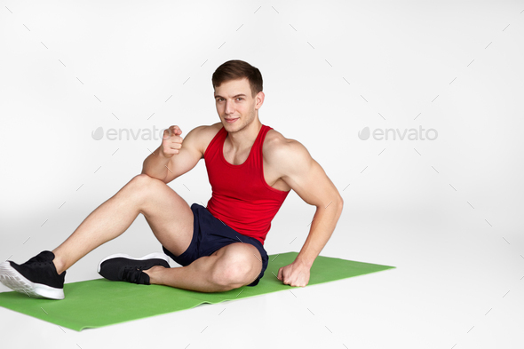 Muscular man sitting on mat Stock Photo by kegfire | PhotoDune