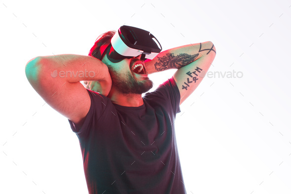 Screaming man in VR glasses covering ears Stock Photo by kegfire ...