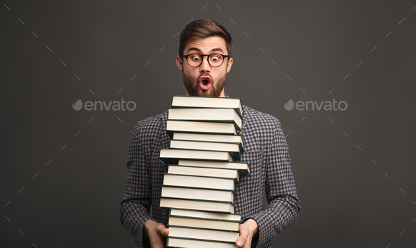 Shocked man with pile of books Stock Photo by kegfire | PhotoDune