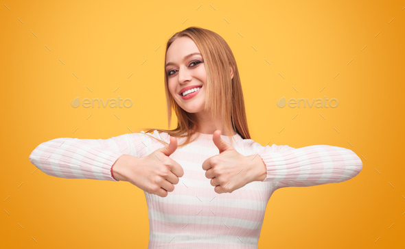 Pretty model holding thumbs up Stock Photo by kegfire | PhotoDune