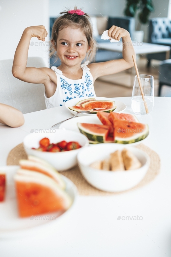 Little girl eating summer food Stock Photo by anita_bonita | PhotoDune