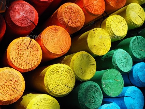 Poles painted in the colors of the rainbow Stock Photo by wikaatje