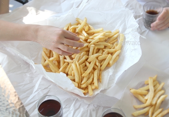 Sharing a package of hot chips (french fries) from the local fish and ...