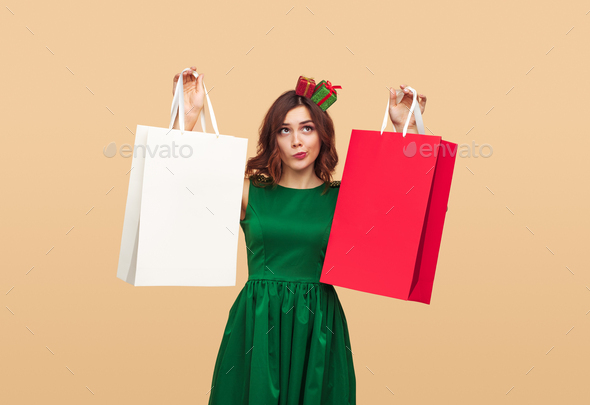Thoughtful female choosing between gifts Stock Photo by kegfire | PhotoDune