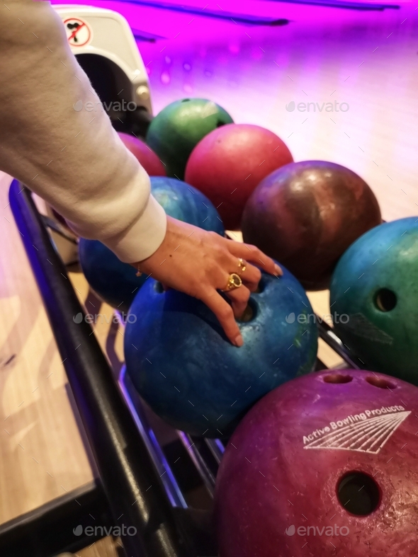 Grabbing a blue bowling ball to throw Stock Photo by wikaatje | PhotoDune