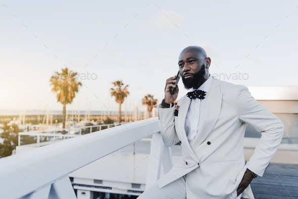 Black dapper man phoning on the roof Stock Photo by SkyNextphoto ...