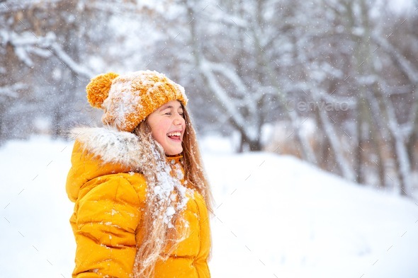 Pretty young teen girl with long hair wearing yellow jacket and knitted ...