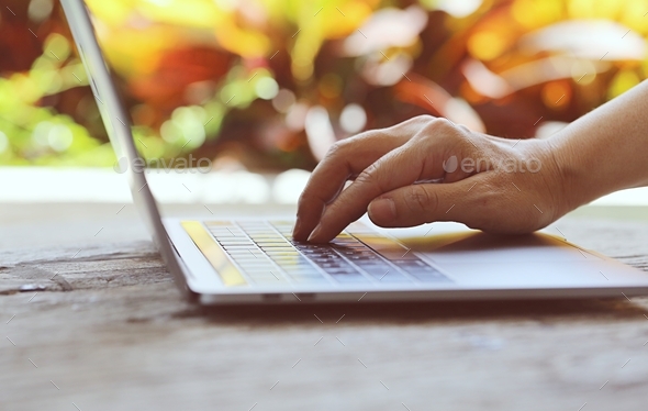 People hand typing on laptop keyboard working relax outdoor at home ...