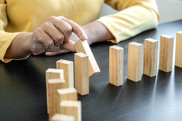 Image of hand stopping falling collapse wooden block dominoes effect ...