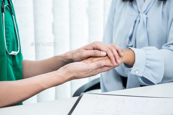 doctor touching patient reassuring for encouragement and empathy to ...