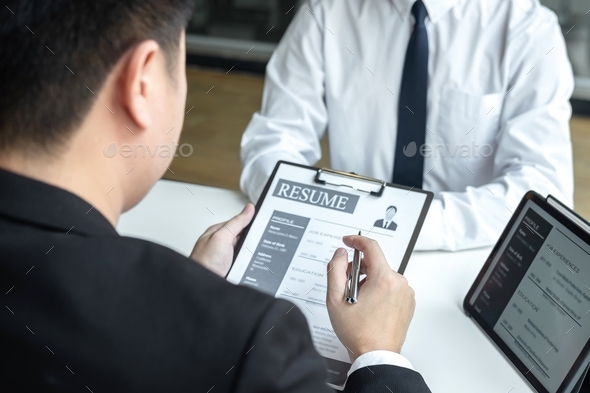 Business interviewer consider and asking about profile of candidate ...
