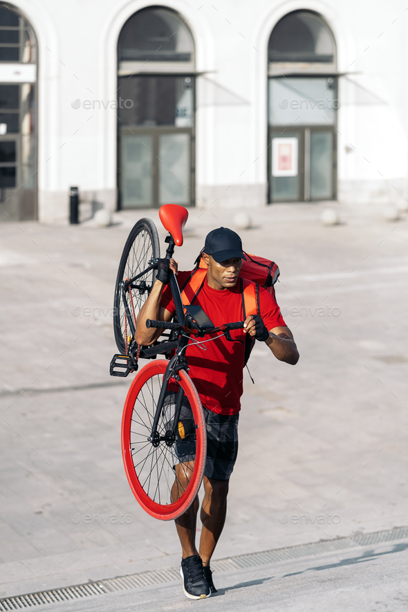 Messenger Man Carrying his Bike Stock Photo by nunezimage | PhotoDune