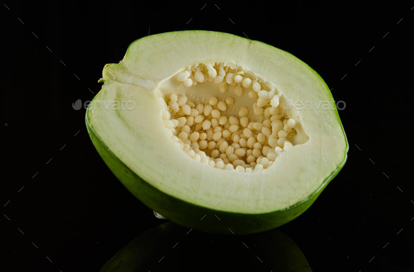 Half green round papaya on black background with reflection Stock Photo ...