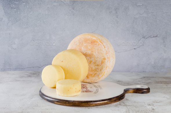 Assorted tasty cheese of different kinds and sizes on table. Stock ...