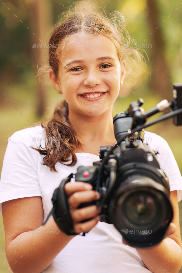 Cute girl shooting a video with a professional video camera Stock Photo ...