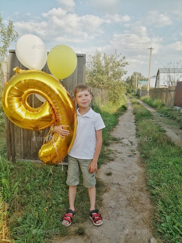 The boy holds the number 9. Birthday of a boy with balloons Stock Photo ...