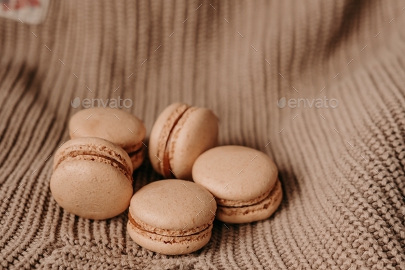 caramel macaroons on a sweater. cozy autumn photography. photograph of ...