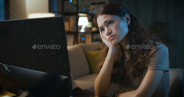Confused woman staring at the computer screen Stock Photo by stockasso
