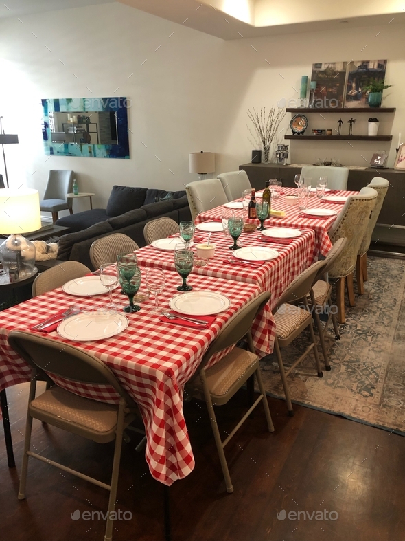 Italian family dinner table set up in the dining room with red and ...