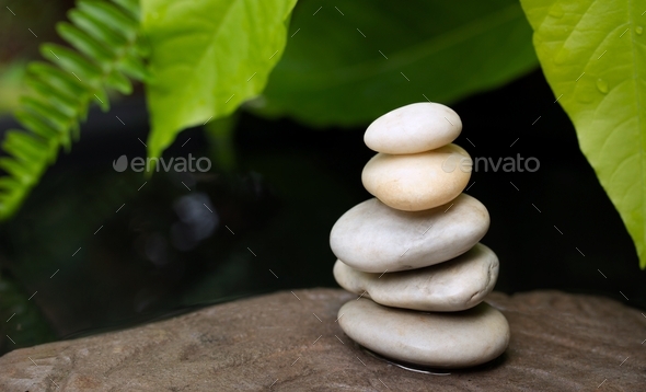 White zen stones with blurred green background Stock Photo by ssumetha