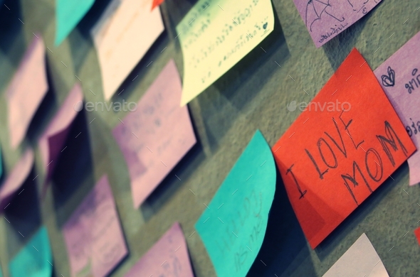 Various colors of post it note paper on board abstract blur background ...