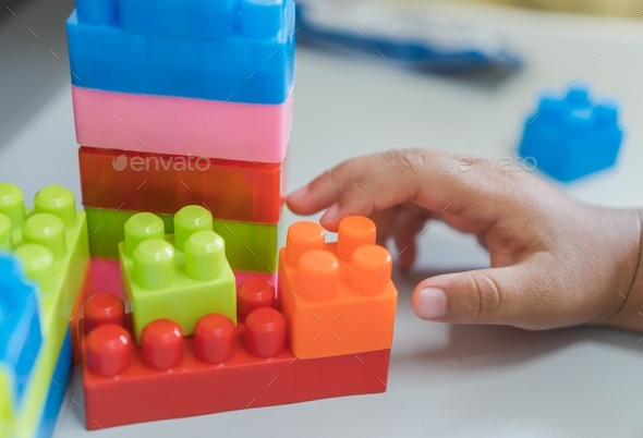 Children hand learning game connect color block toy Stock Photo by ssumetha