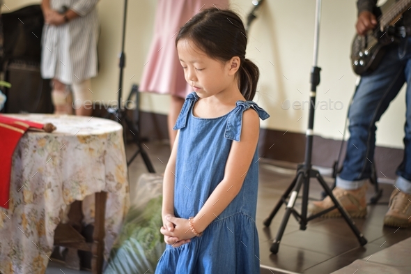 Religious christian girl praying in church Stock Photo by crazyphotography