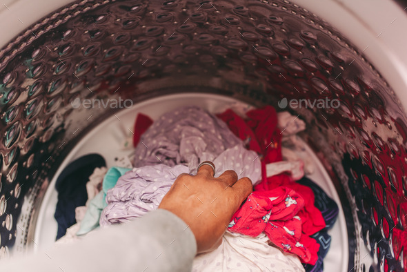 Married man doing the laundry, chores , black, African American ...