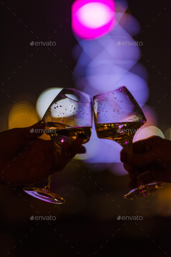 Two people cheering with glasses at night Stock Photo by laru_ka ...