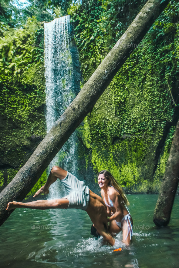 Falling off a log by a waterfall Stock Photo by rikkicarman1 | PhotoDune