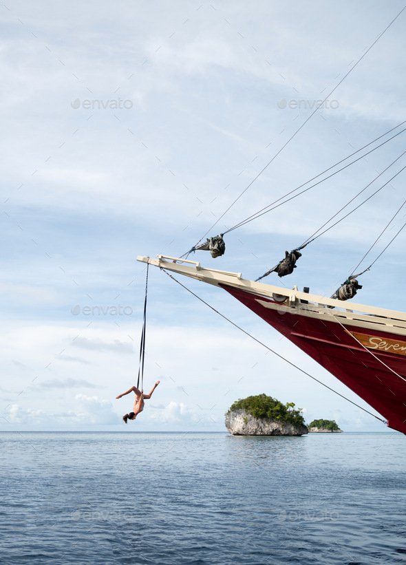 Circus girl hanging from the front of a boat Stock Photo by rikkicarman1