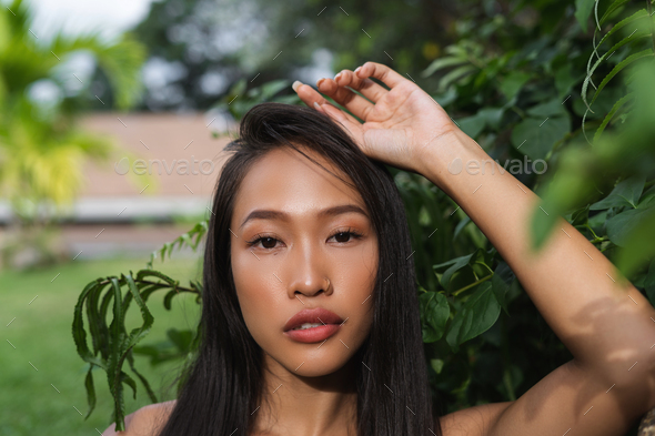 Beautiful asian thai woman with soft smooth clean dark tanned skin Stock Photo by kroshka__nastya
