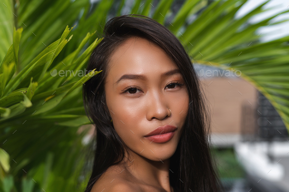 Beautiful asian thai woman with soft smooth clean dark tanned skin ...