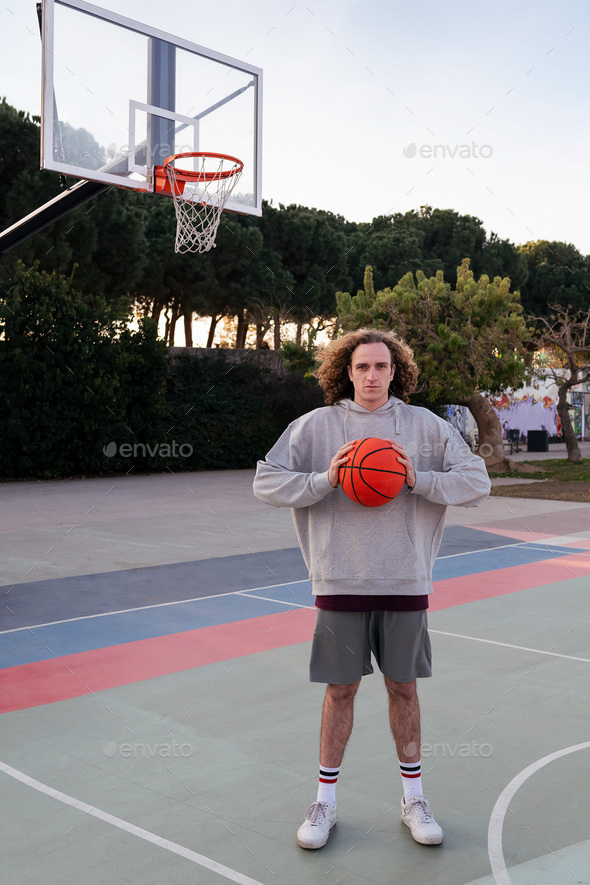 man on a basket court holding a ball in his hands Stock Photo by Raul ...